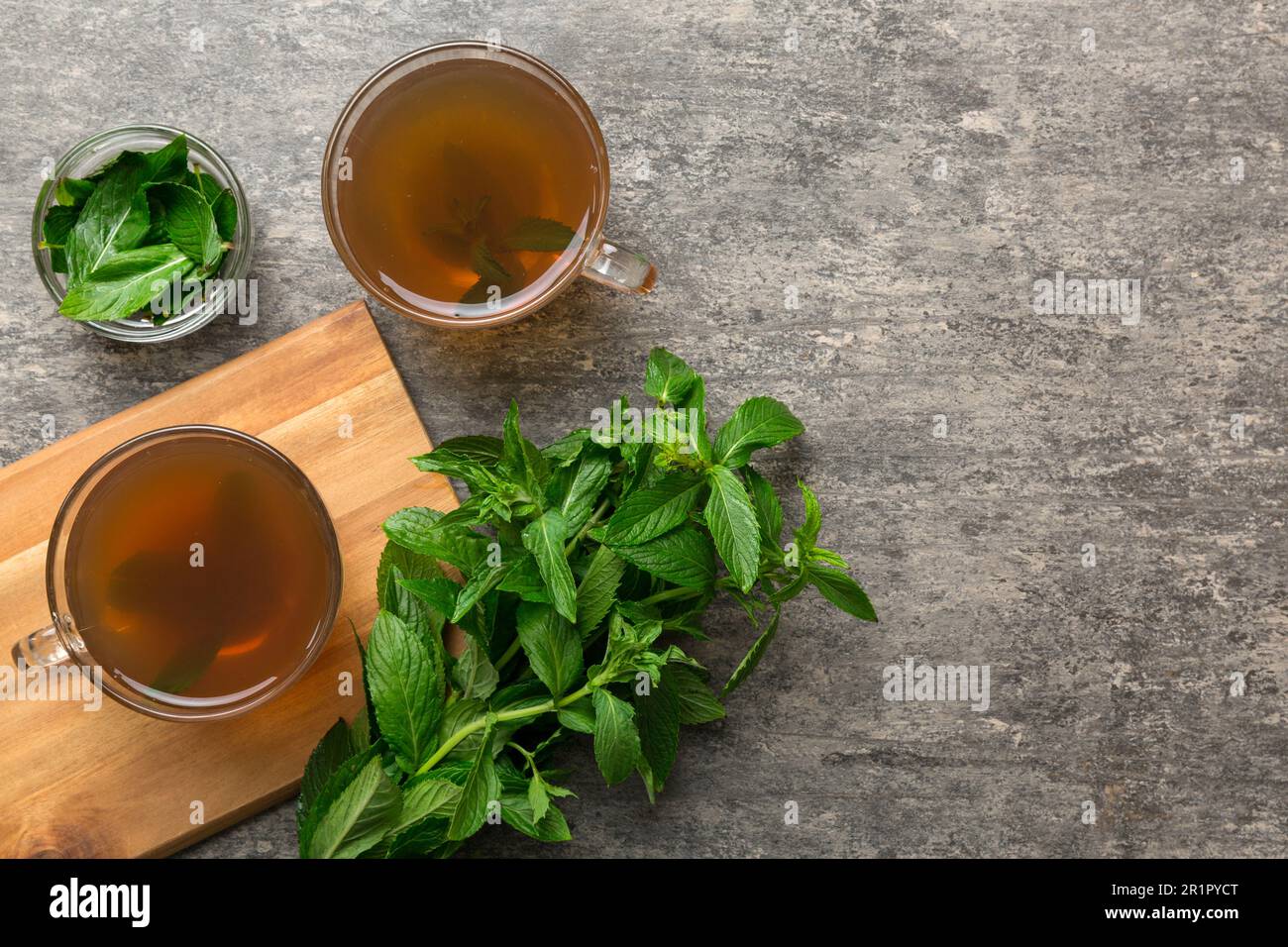 Cup of mint tea on table background. Green tea with fresh mint top view ...