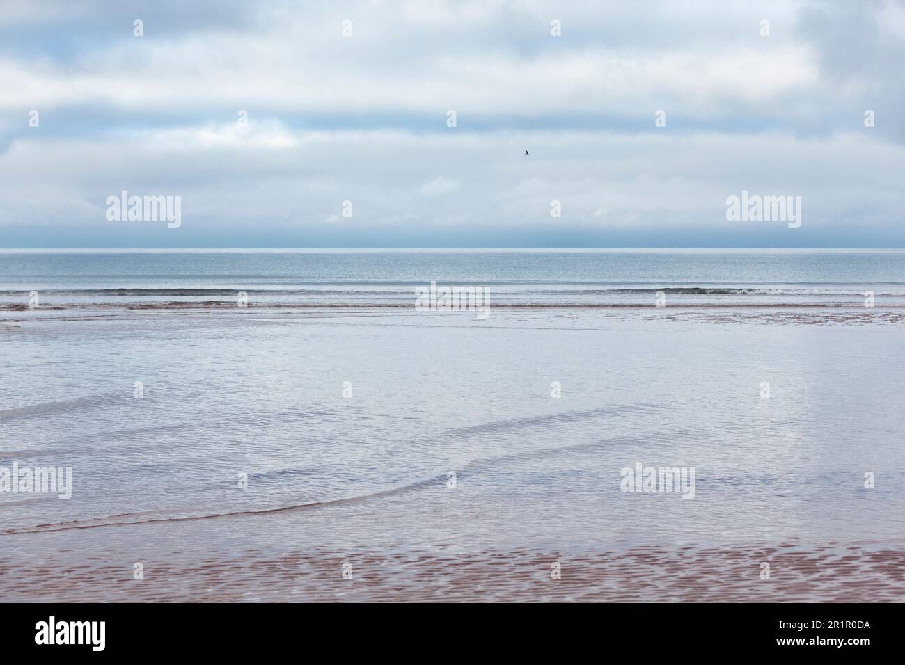 Low tide on beach with no wind Stock Photo - Alamy