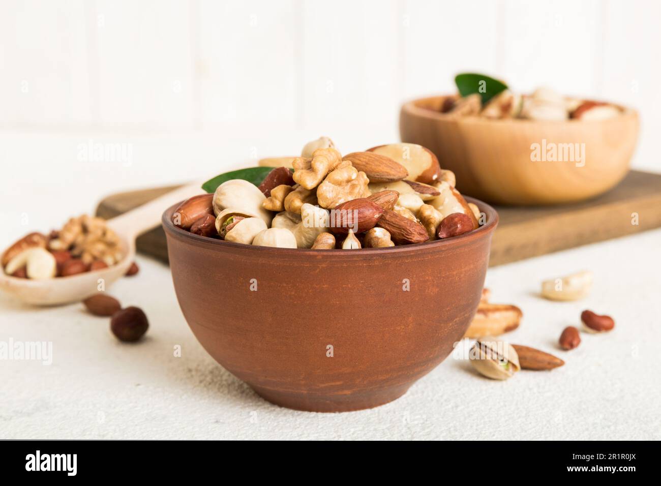 mixed nuts in bowl. Mix of various nuts on colored background ...