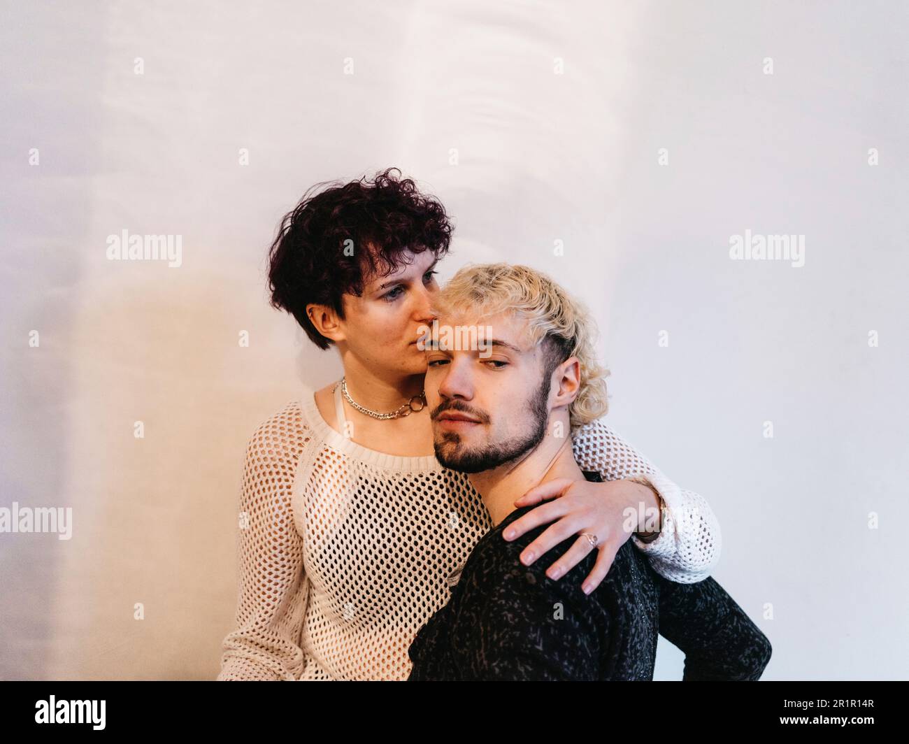 Non-binary couple on sofa Stock Photo - Alamy