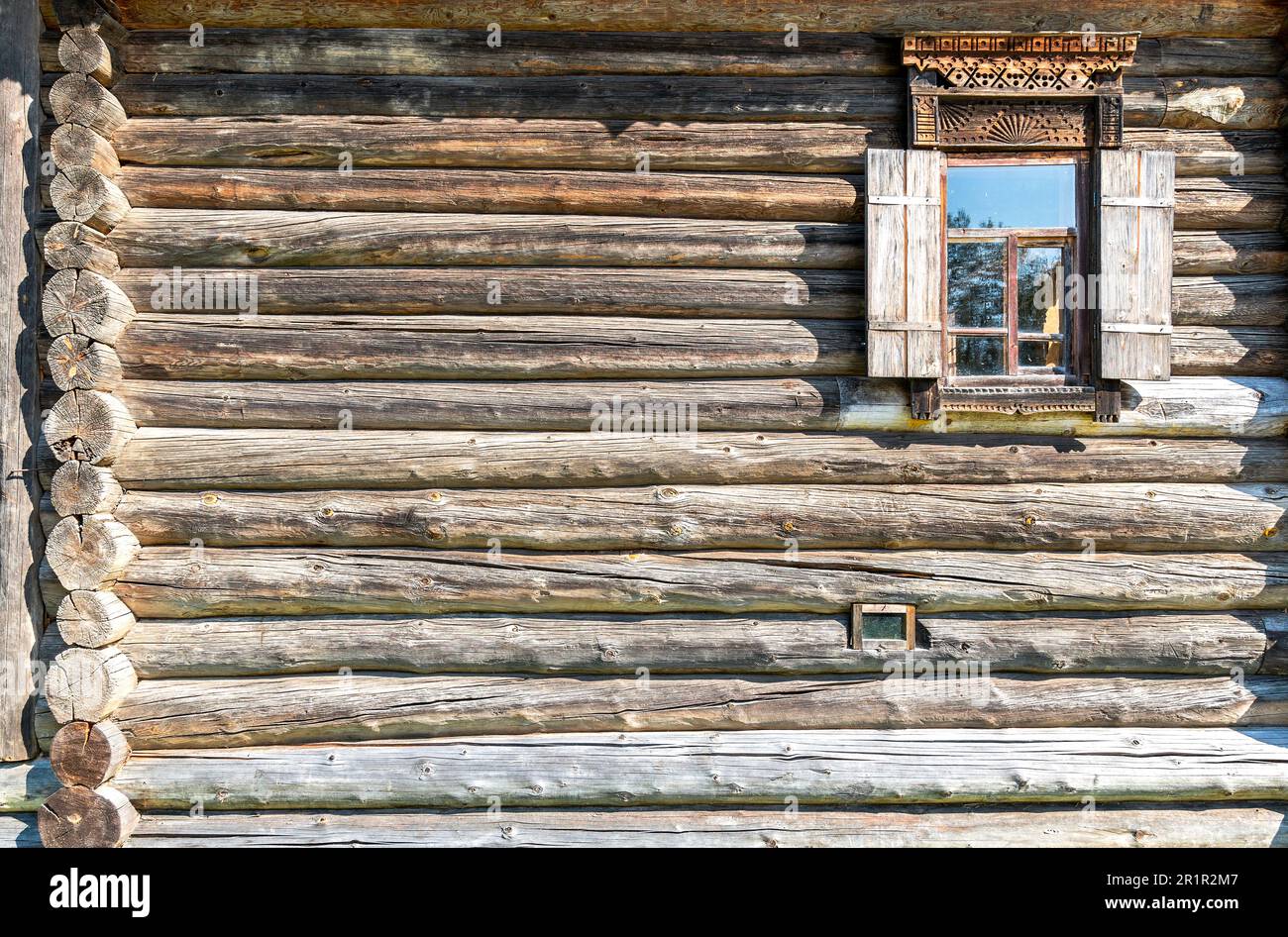 Window of old traditional russian log house with carved wooden trim ...