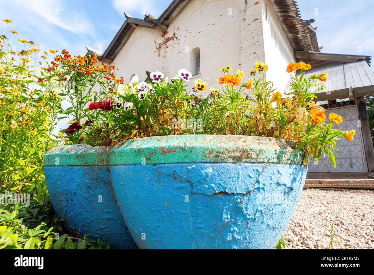 Decorative pansy flowers in stone vases against the background of an ...