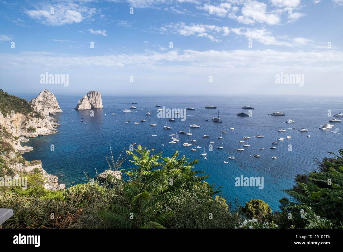 Yachts and sailboats in front of faraglioni rocks in capri hi-res stock ...