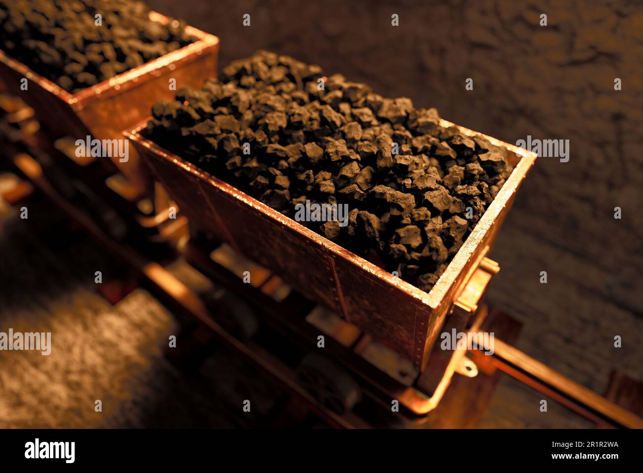 Seven old mine wagons or carts full of coal slowly moving through the ...