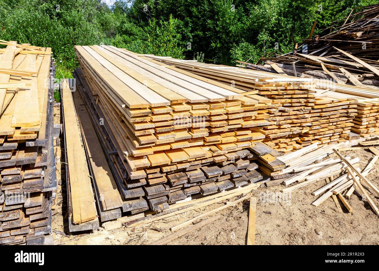 Pile of wooden boards in the sawmill. Warehouse for sawing boards on a ...