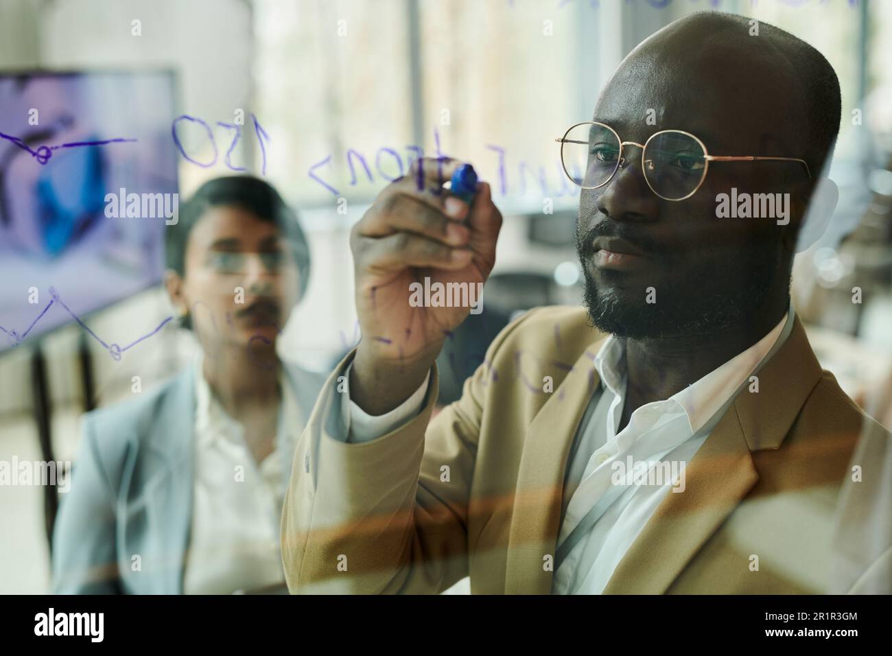 Focus on young serious African American businessman or coach with blue ...