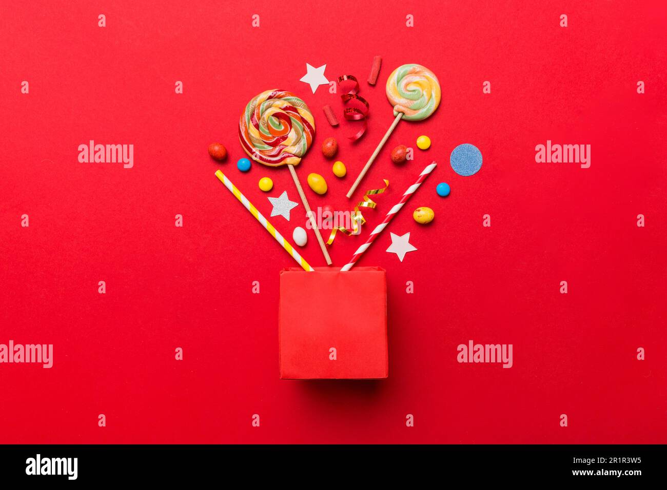 gift box in corner full of assorted traditional candies falling out on ...