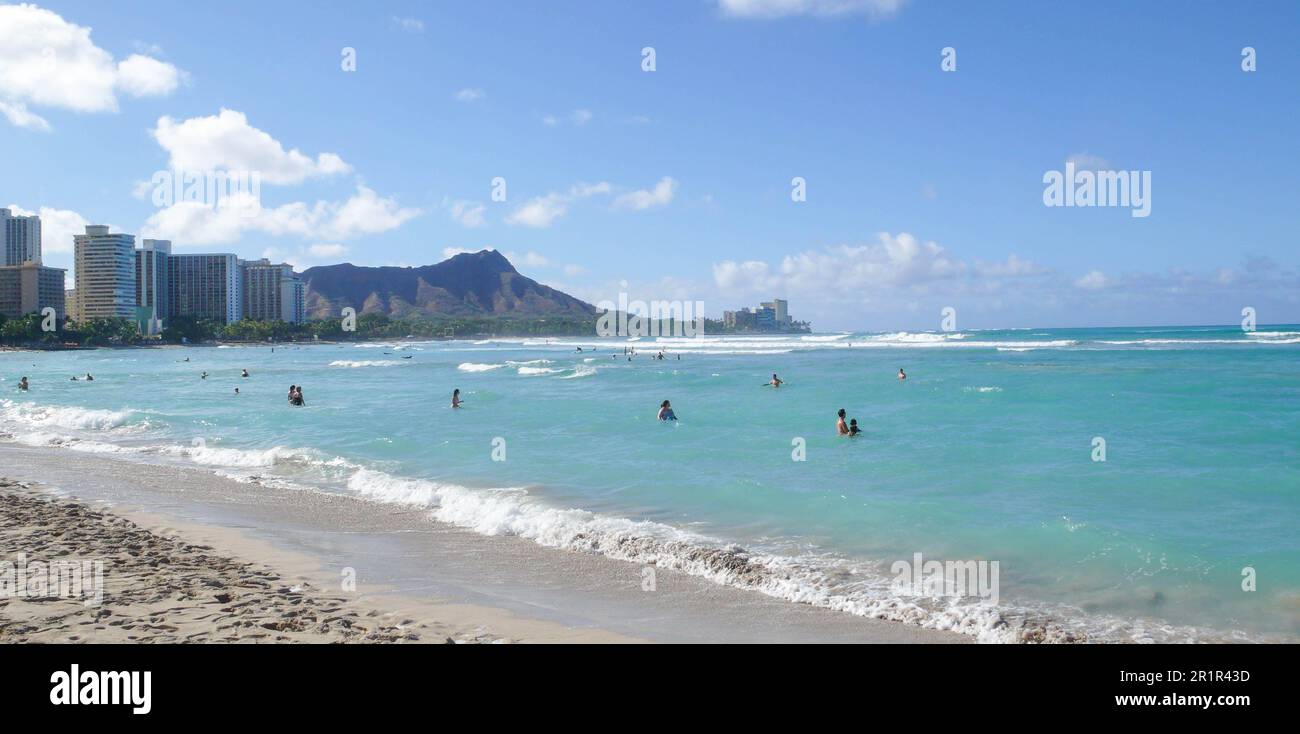 Waikiki Beach with swimmers in the water and Diamond Head in the ...