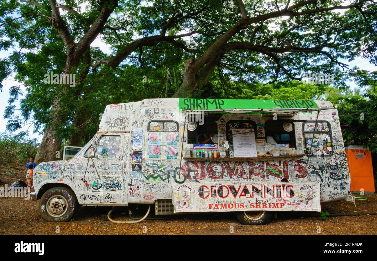 A roadside shrimp RV food truck covered in decorative graffiti parked ...