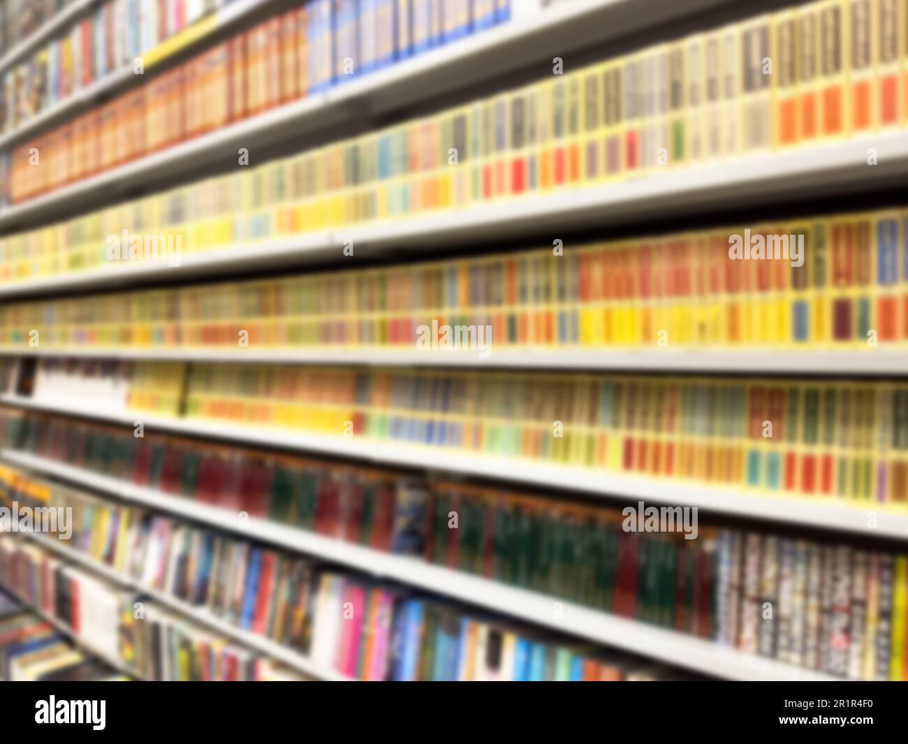 Abstract blurred modern white bookshelves with books. Blur manuals and ...