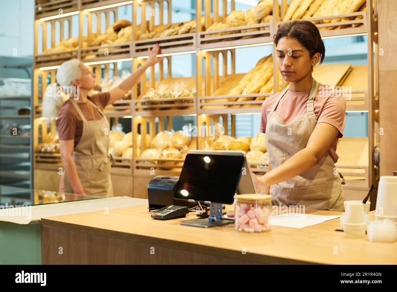 Black woman entering tablet desk hi-res stock photography and images ...