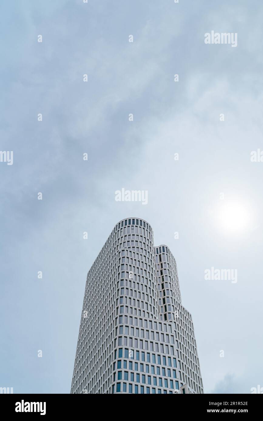 A majestic, towering skyscraper rises into the deep blue sky in this ...