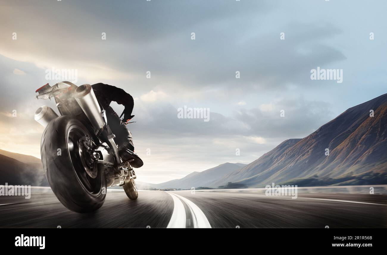 Back bottom view image of man, professional motorbike rider on road ...