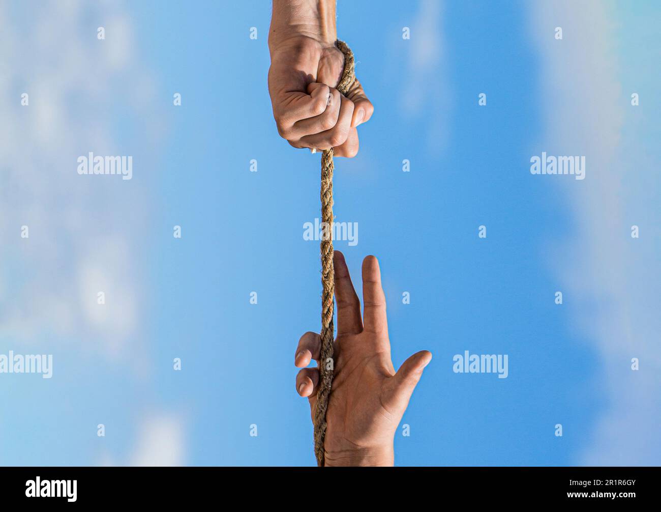 Rescue, help, helping gesture or hands. Conflict tug of war. Rope, cord. Hand holding a rope ...