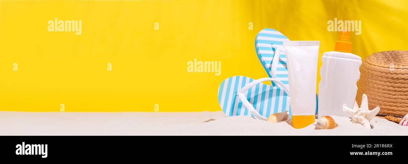 Sunscreen bottles on sand sea beach, electric yellow background. High ...