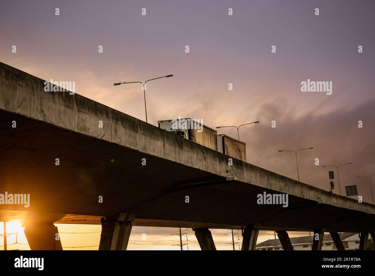 Bottom view of elevated concrete highway with truck driving. Overpass ...