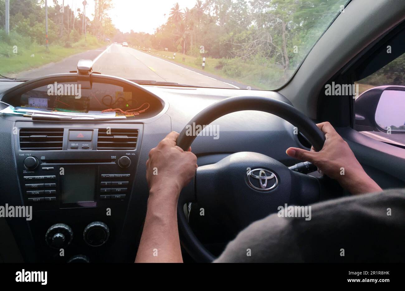 Driving concept, Hand driving a car on the road blurred background ...