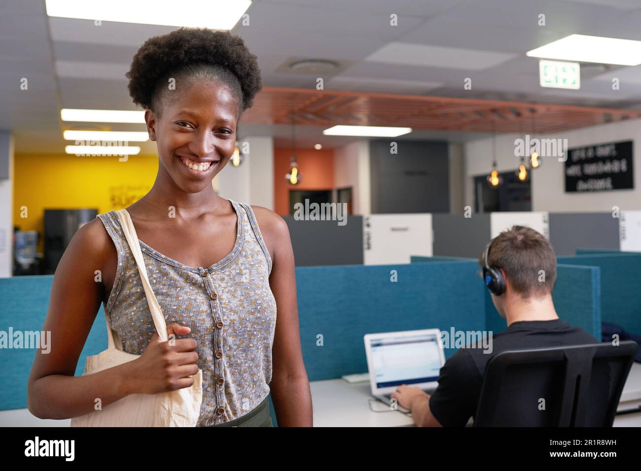 Portrait of a young Black college student arriving at campus library ...