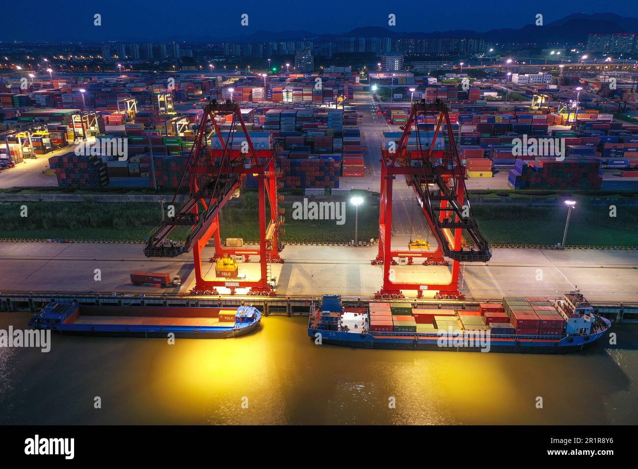 NANJING, CHINA - MAY 15, 2023 - Cargo ships load containers at the ...