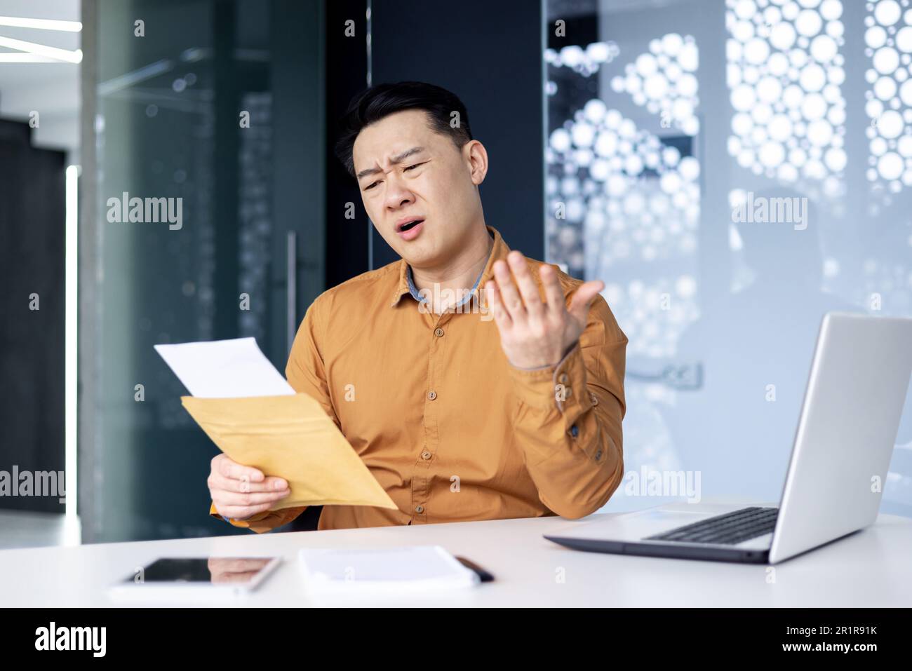 Disappointed Asian man received letter, man reading bad message ...