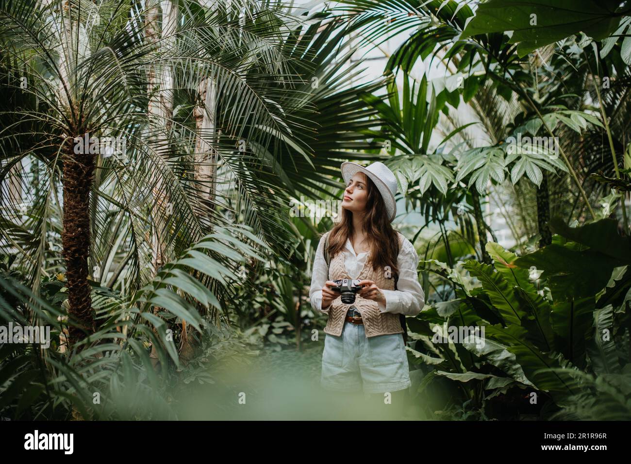 Portrait of young woman in botanical garden Stock Photo - Alamy