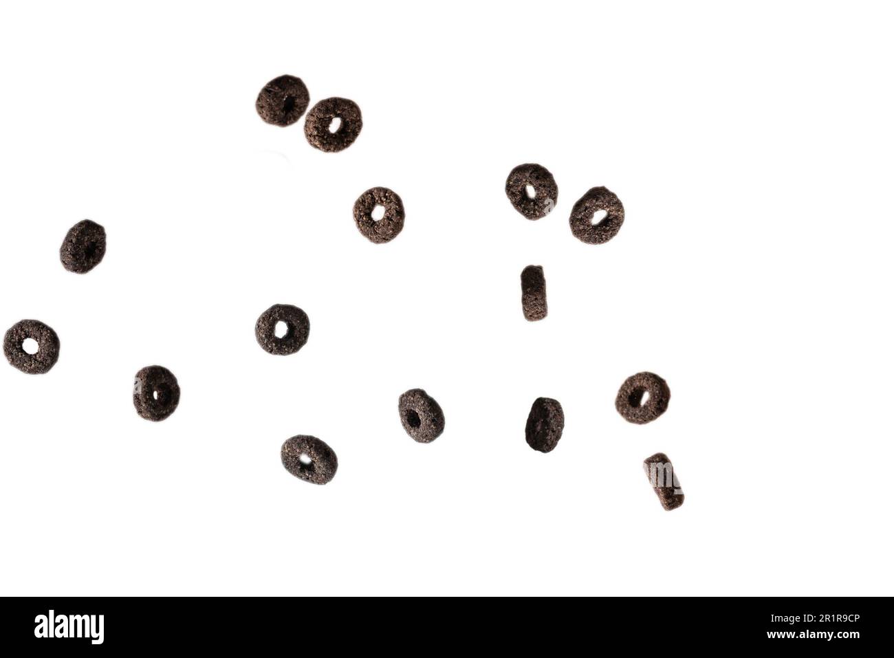 Chocolate rings cereal spill out into a bowl. Breakfast. Isolated on a ...