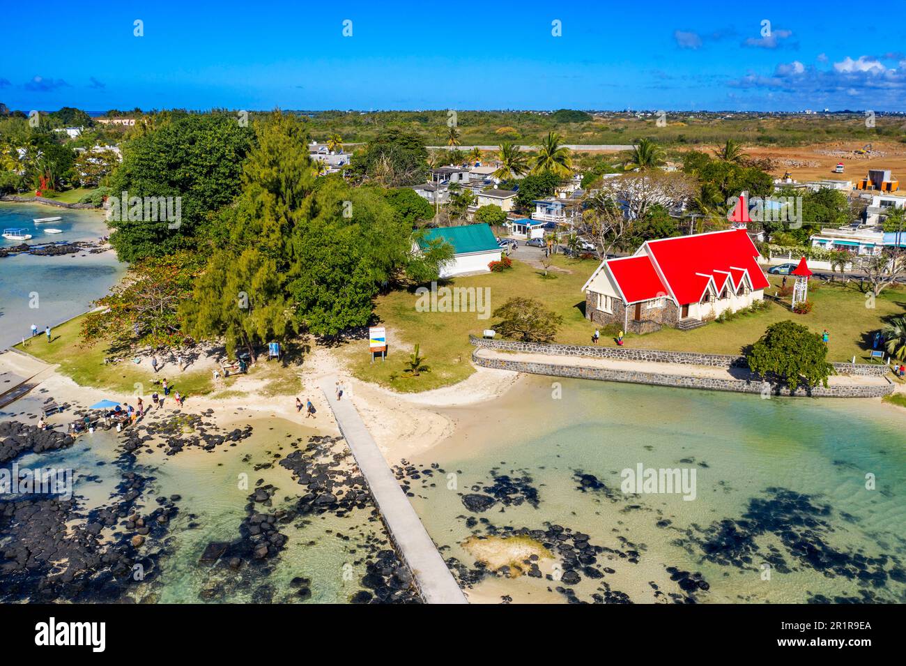 Aerial view of the traditional catholic red church near the beach in ...