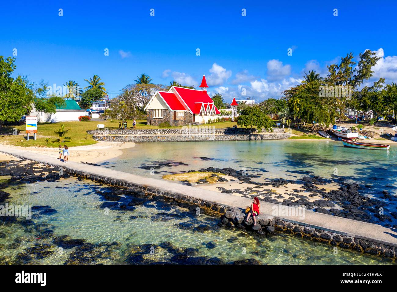 Aerial view of the traditional catholic red church near the beach in ...