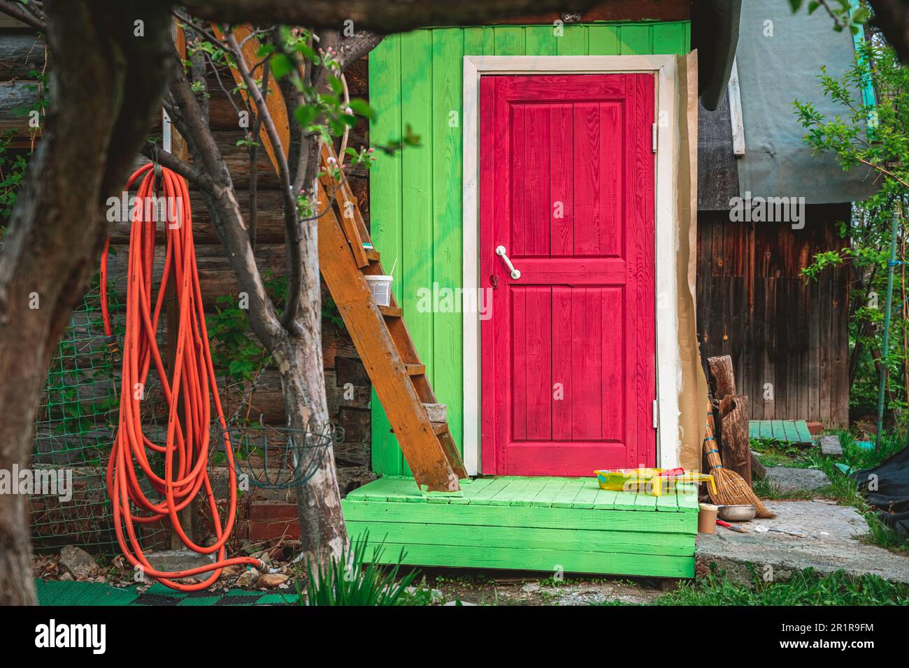 the door of a wooden house painted in a bright purple, pink, fuchsia ...