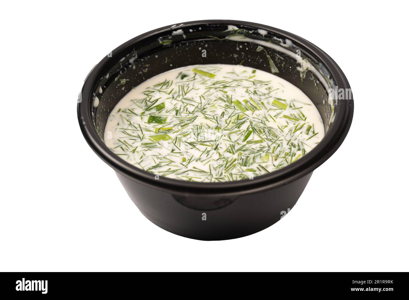 Traditional summer soup okroshka in a black plastic box isolated on a ...