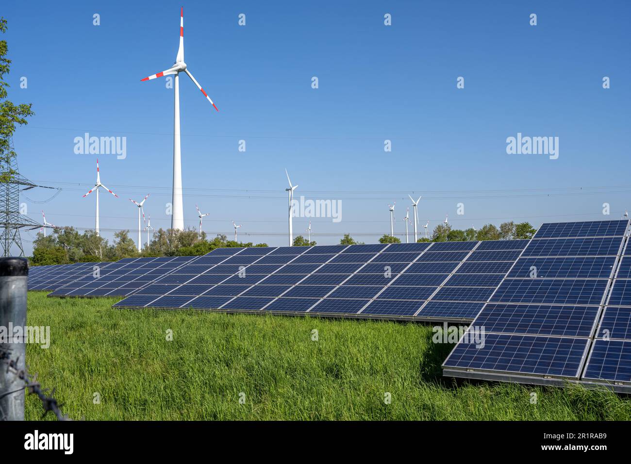 Solar power panels with wind turbines and power lines seen in Germany ...
