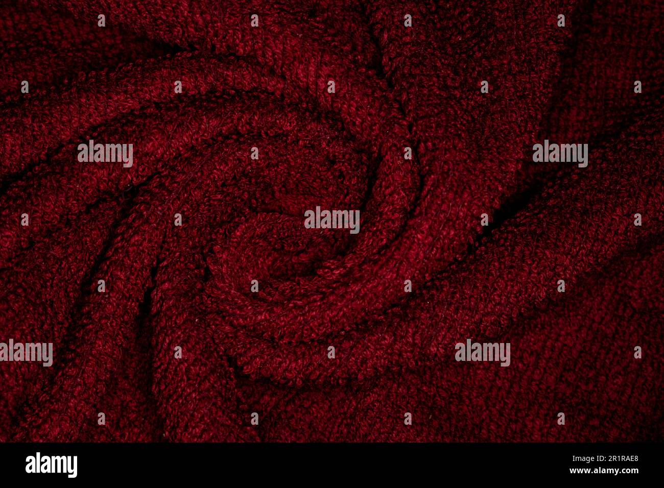 close up, wet deep red towel spiraled, high contrast, heavy texture ...