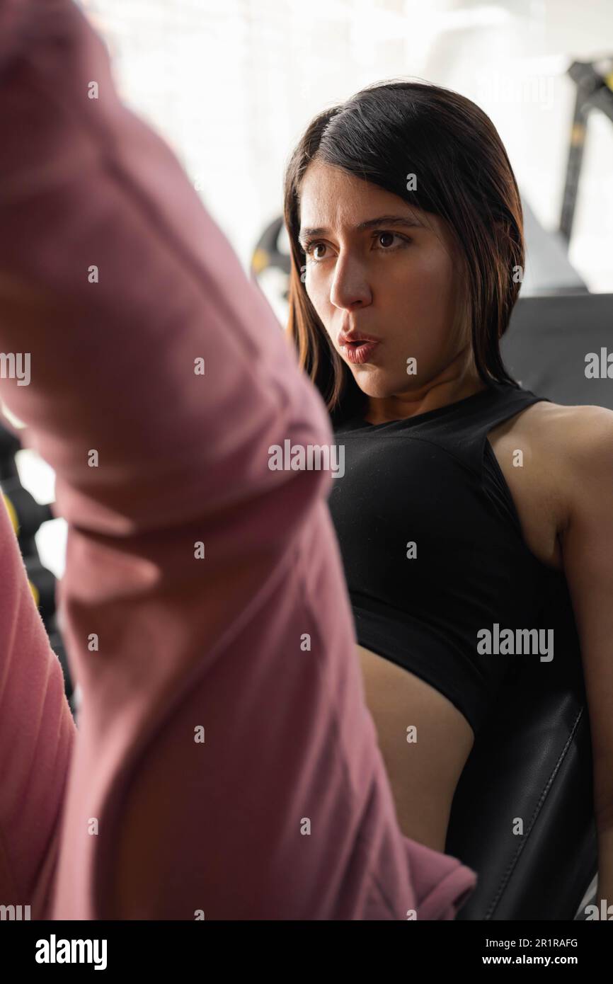 lifestyle of young woman exercising on a gym machine, physical training ...