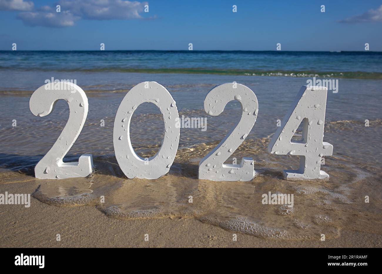 Numerals 2024 wooden white stand on the seashore Stock Photo - Alamy