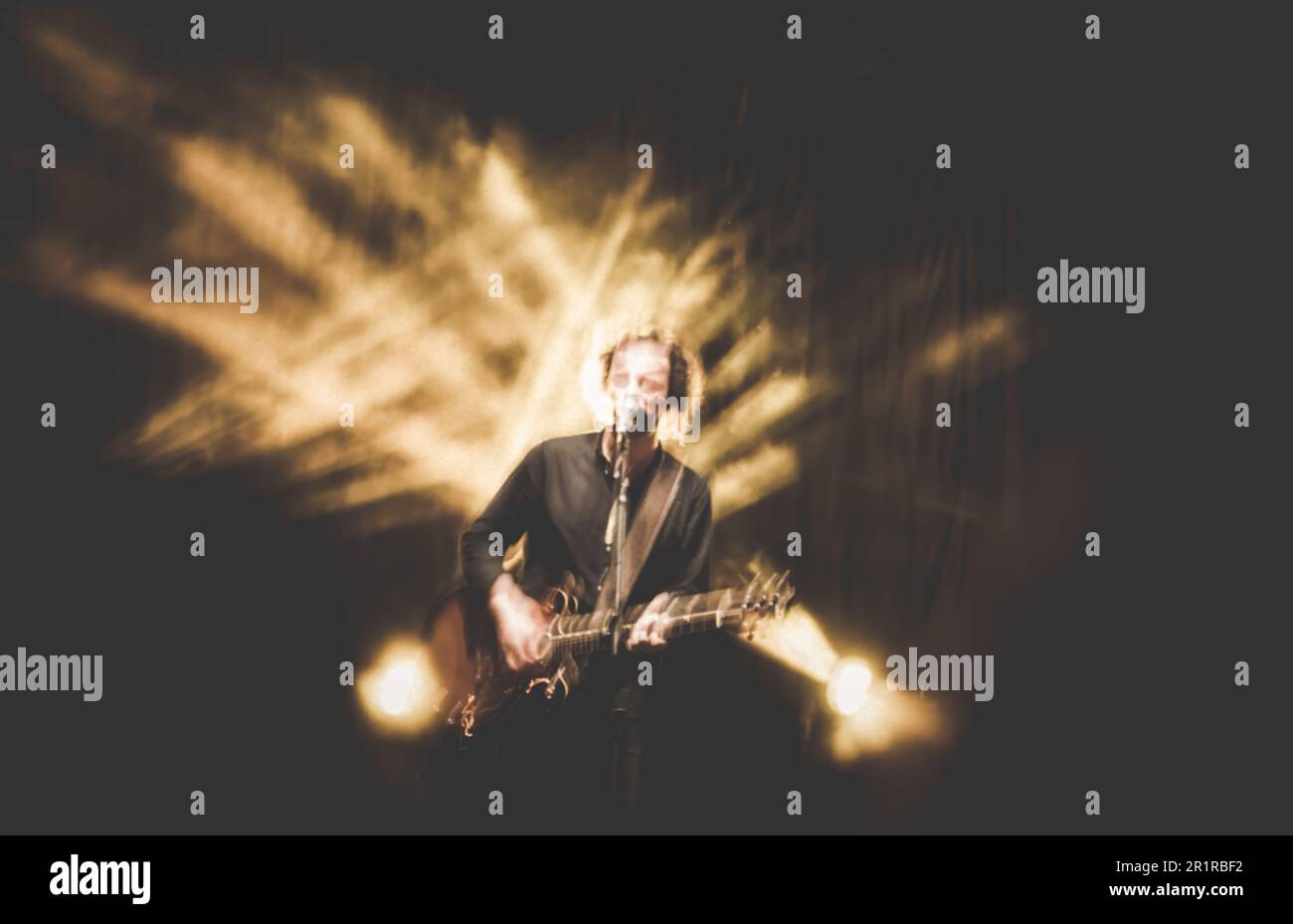 Unknown singer on the stage at a concert. Stage lights at a music ...