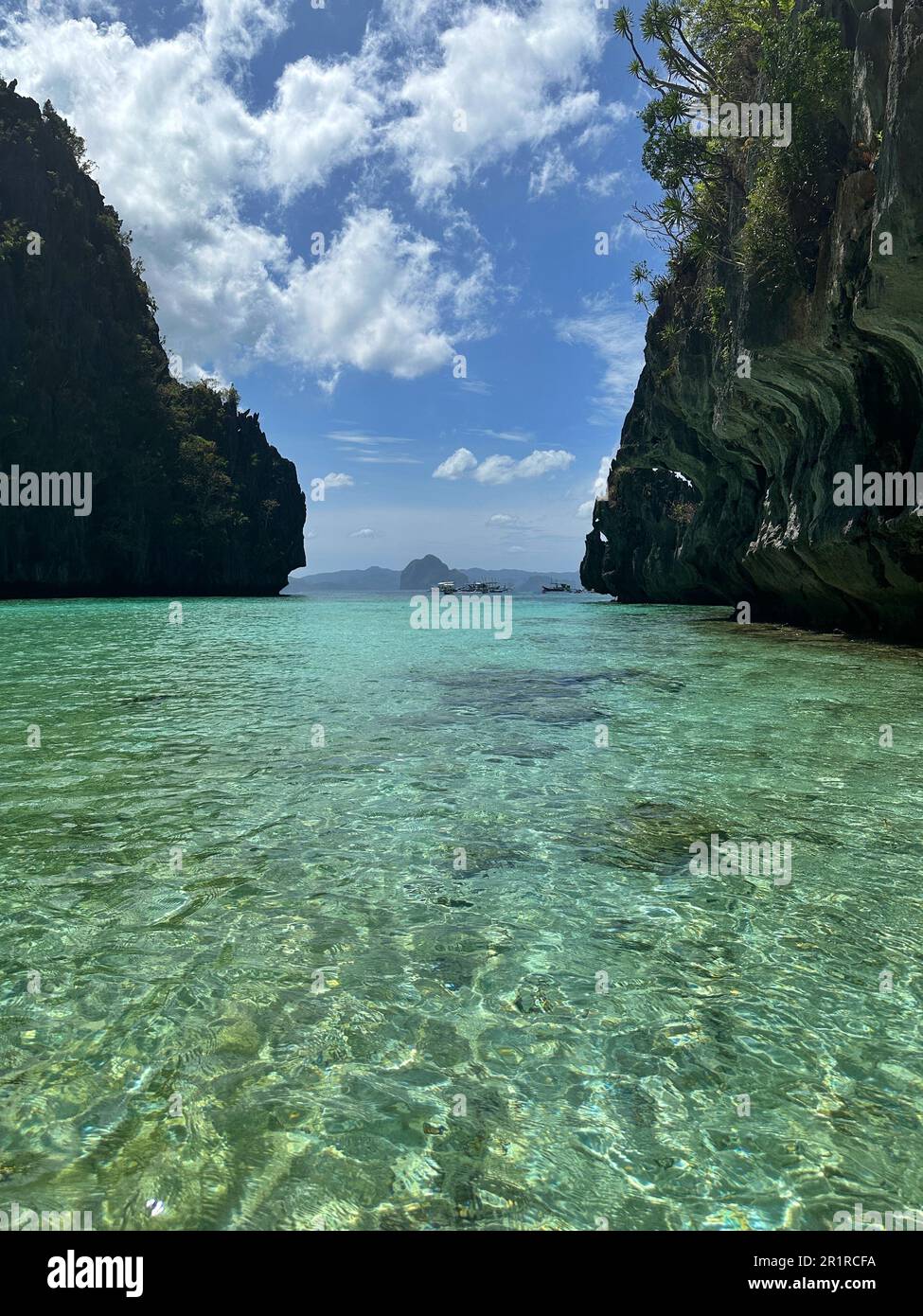 Limestone cliffs and boats moored at entrance to the Big Lagoon, El ...