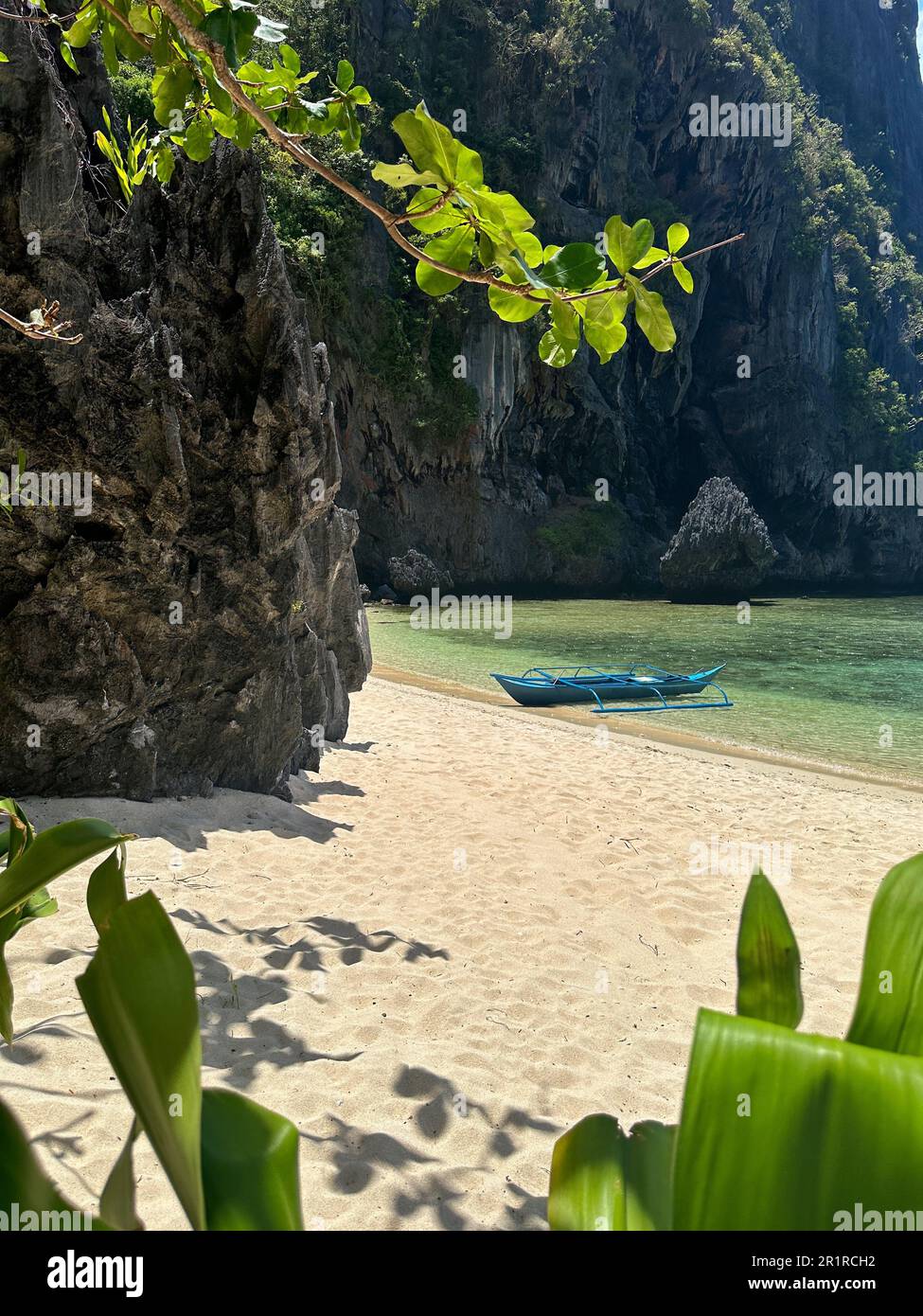 Traditional bangka boat moored on beach, Miniloc Island, Palawan ...