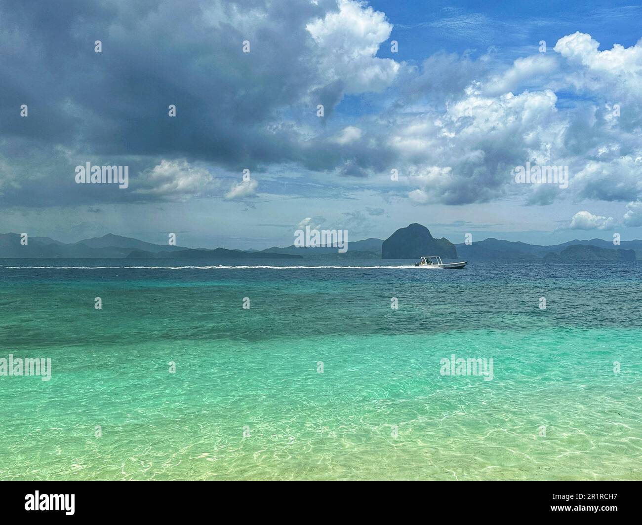 Speedboat sailing in tropical sea with storm approaching, Palawan ...