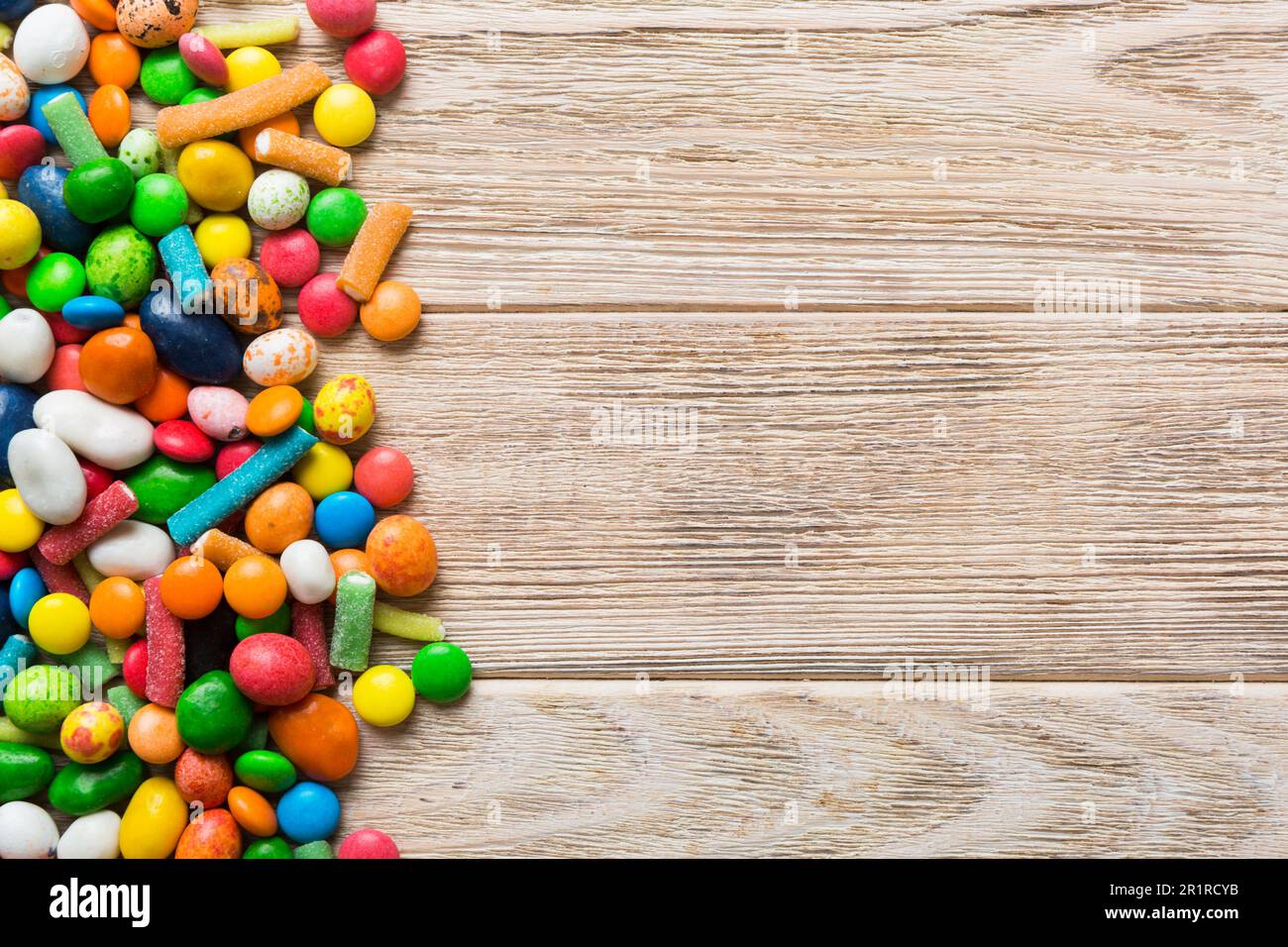 Mixed collection of colorful candy, on colored background. Flat lay ...