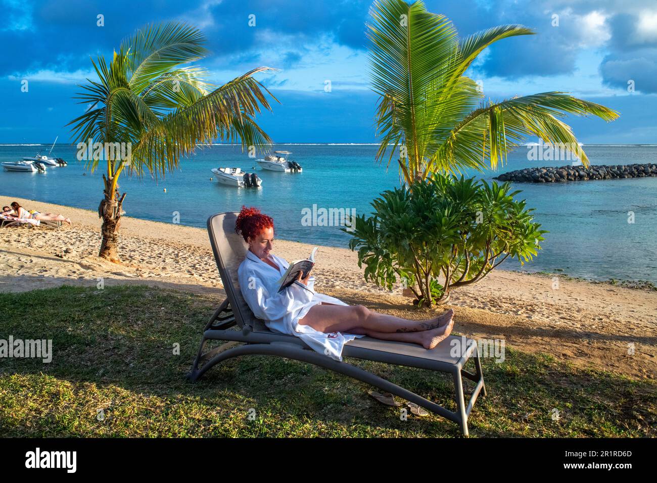 A tourist woman relaxes in a hammock on the beach on Heritage Awali ...