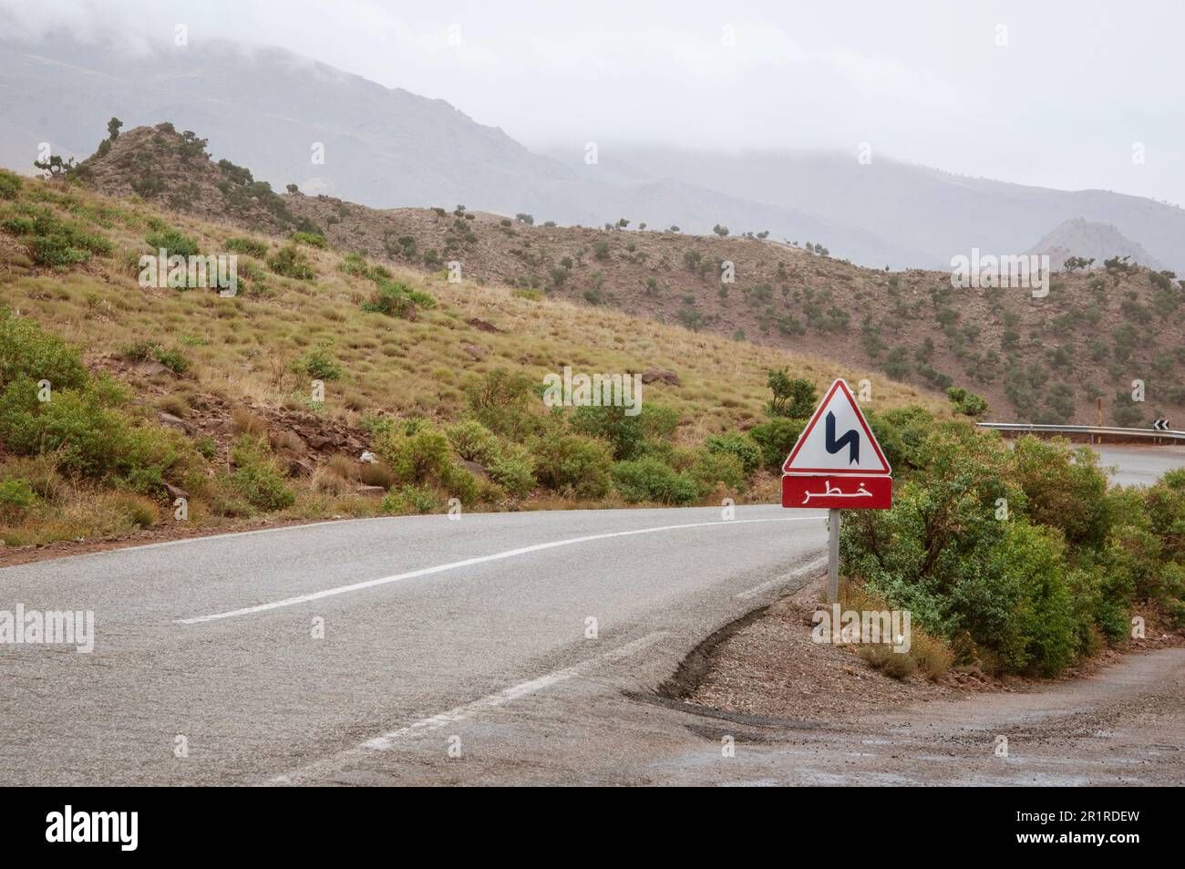 Traffic sign on a curve in the road, Morocco Stock Photo - Alamy