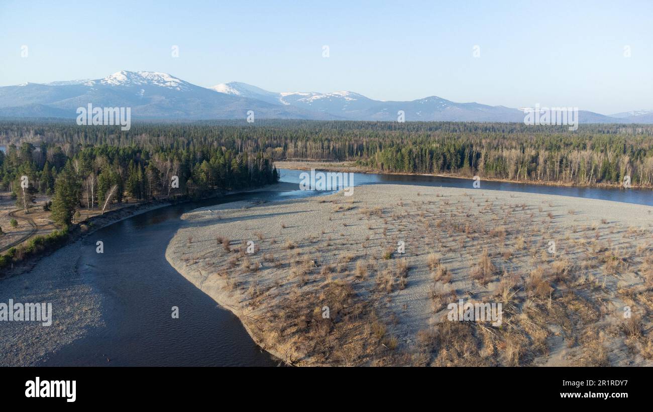 Aerial view of mountain river in taiga. Forest in early spring in ...