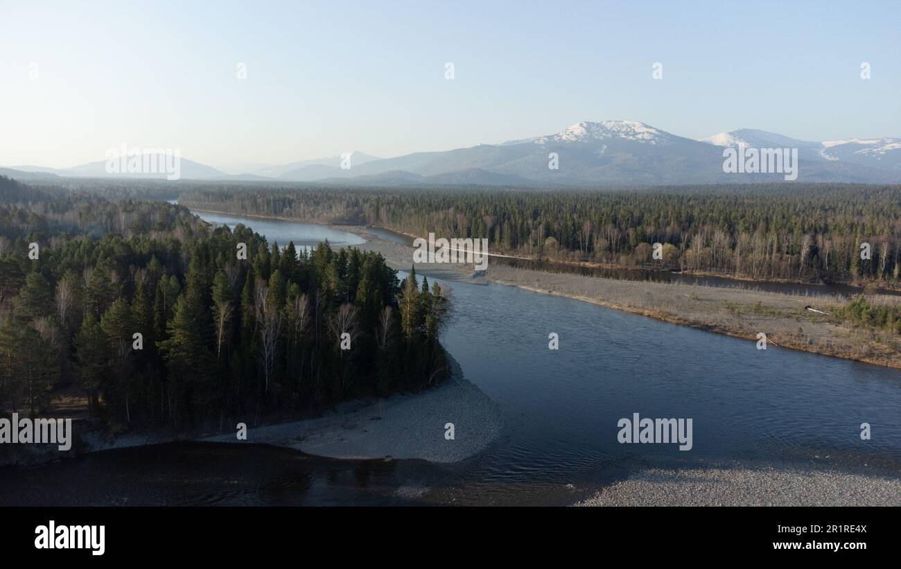 Aerial view of mountain river in taiga. Forest in early spring in ...