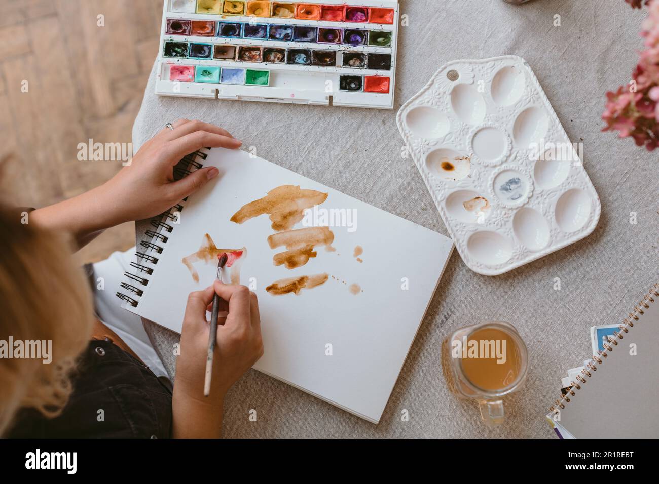 Overhead view of a woman painting with watercolour paints Stock Photo ...