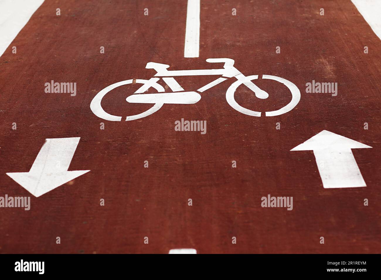New marking bike path. White bicycle symbol and two oposite arrows on ...