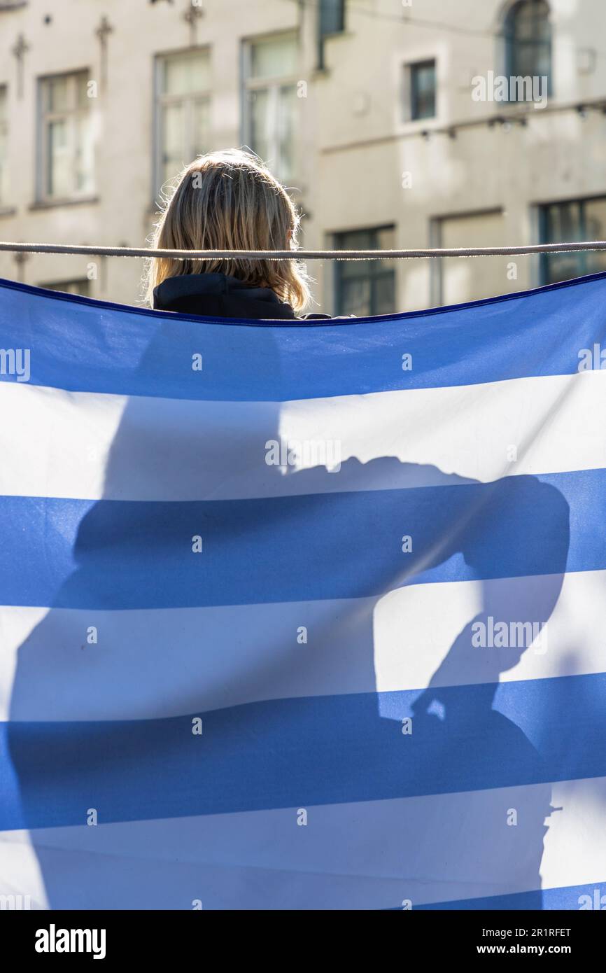 Cast shadow of a backlit person on a canvas made of white and blue ...
