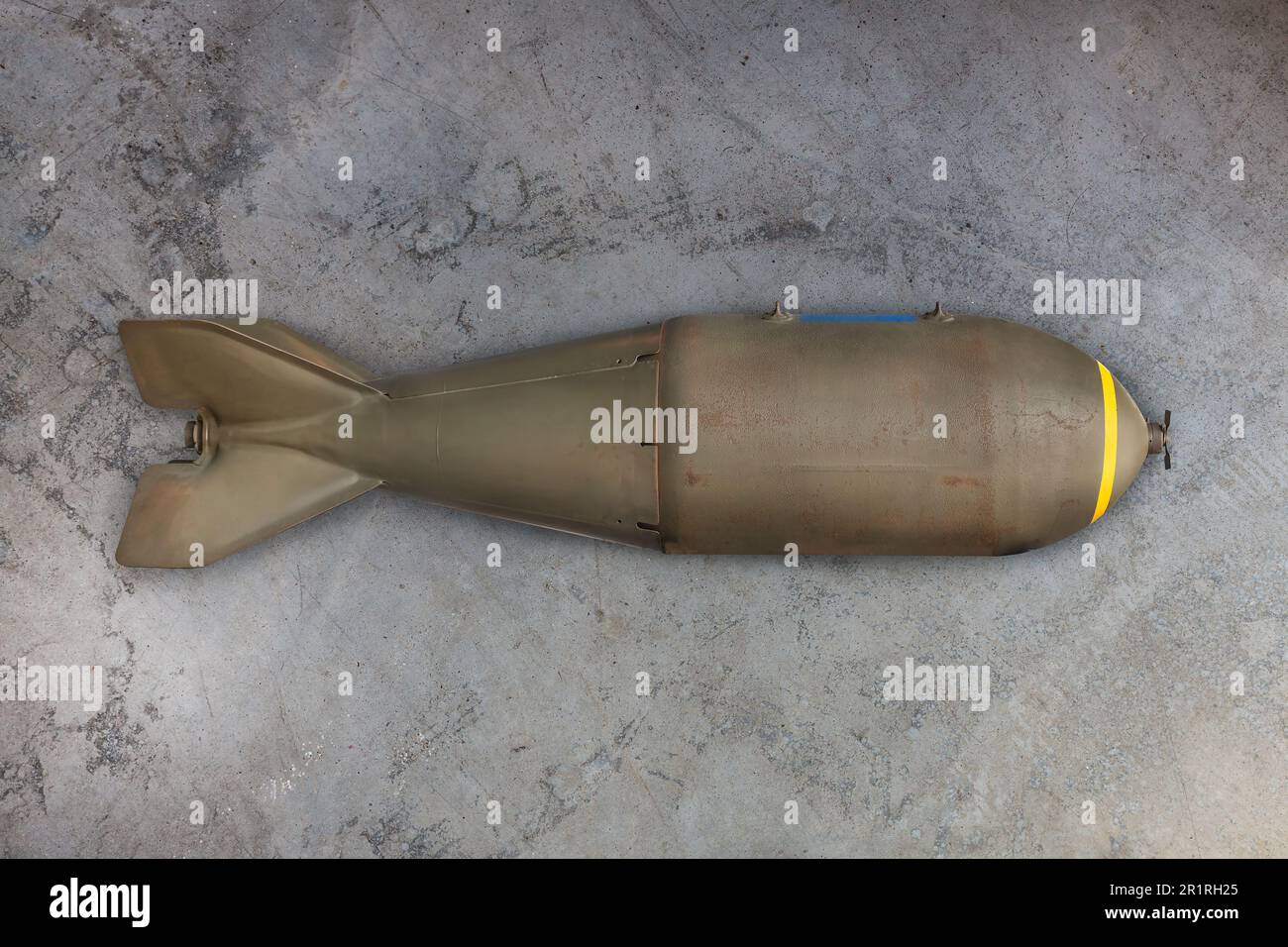 Ancient military missile bomb in front of an eroded grey background ...