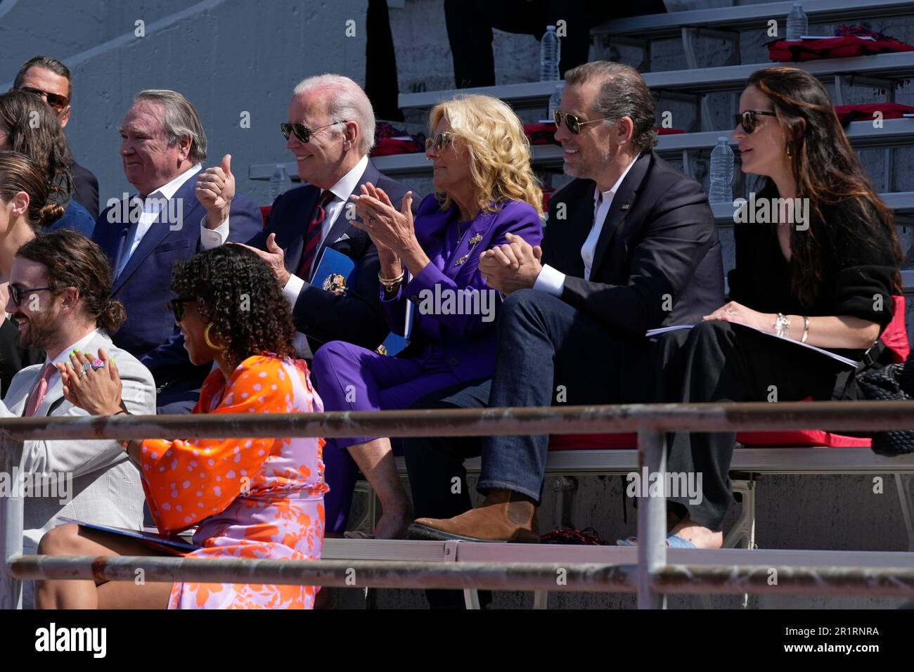 President Joe Biden sits with his family as he attends his ...