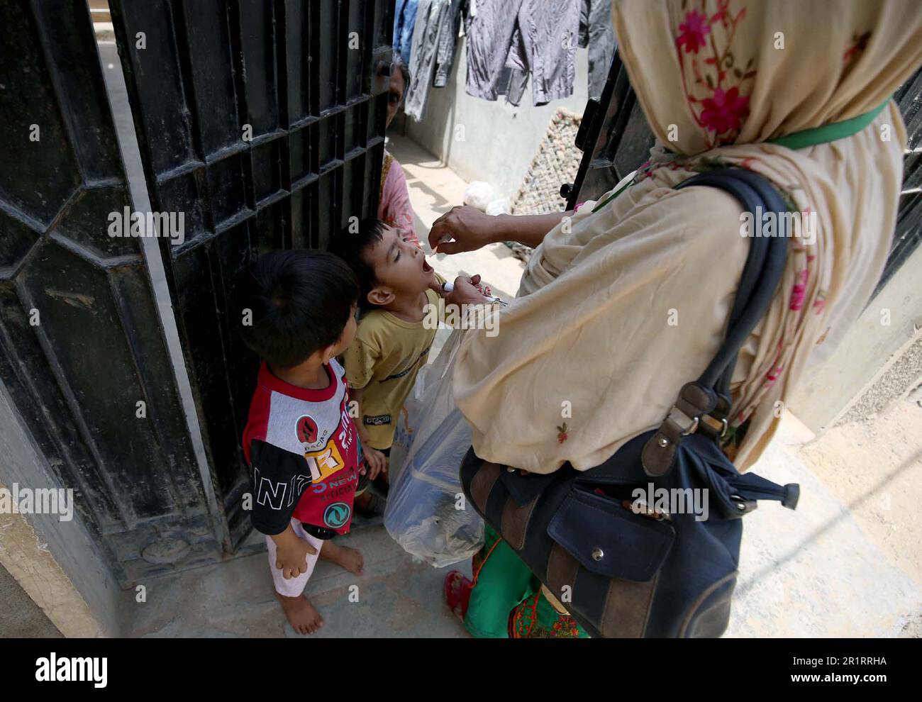 Health worker administrates polio-vaccine drops to a child during anti ...