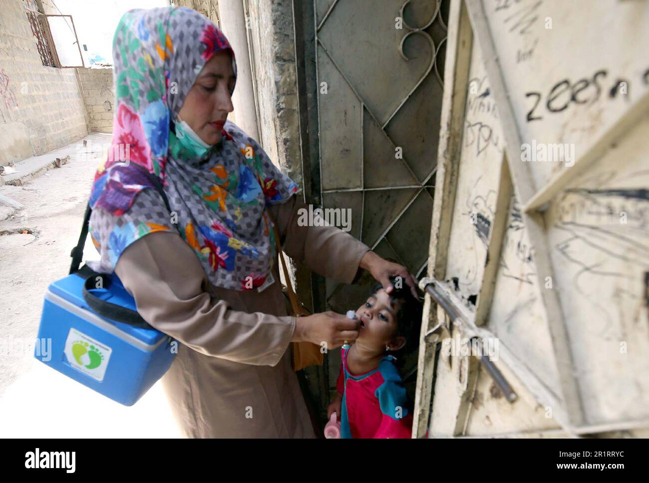 Health worker administrates polio-vaccine drops to a child during anti ...